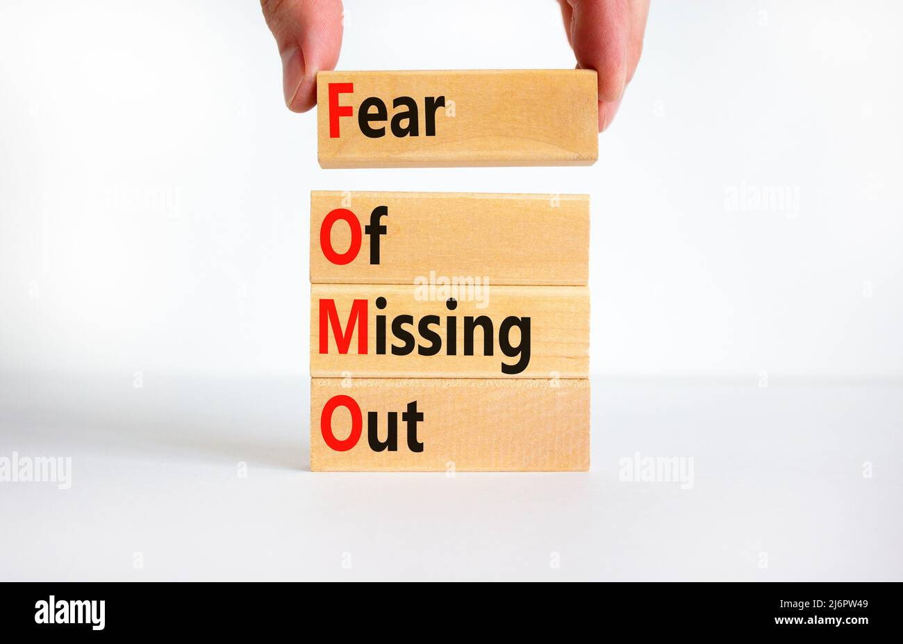 FOMO fear of missing out symbol. Concept words FOMO fear of missing out on wooden blocks on a ...