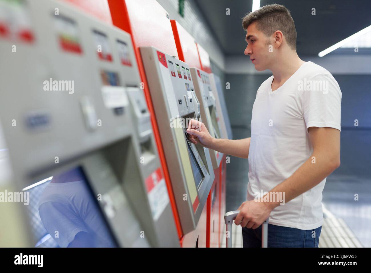 Passenger purchasing ticket at terminal Stock Photo - Alamy