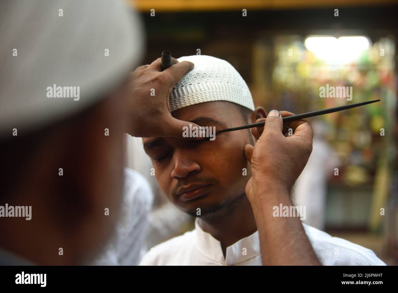 May 3, 2022, Kolkata, West Bengal, India: A man is seen applying surma ...