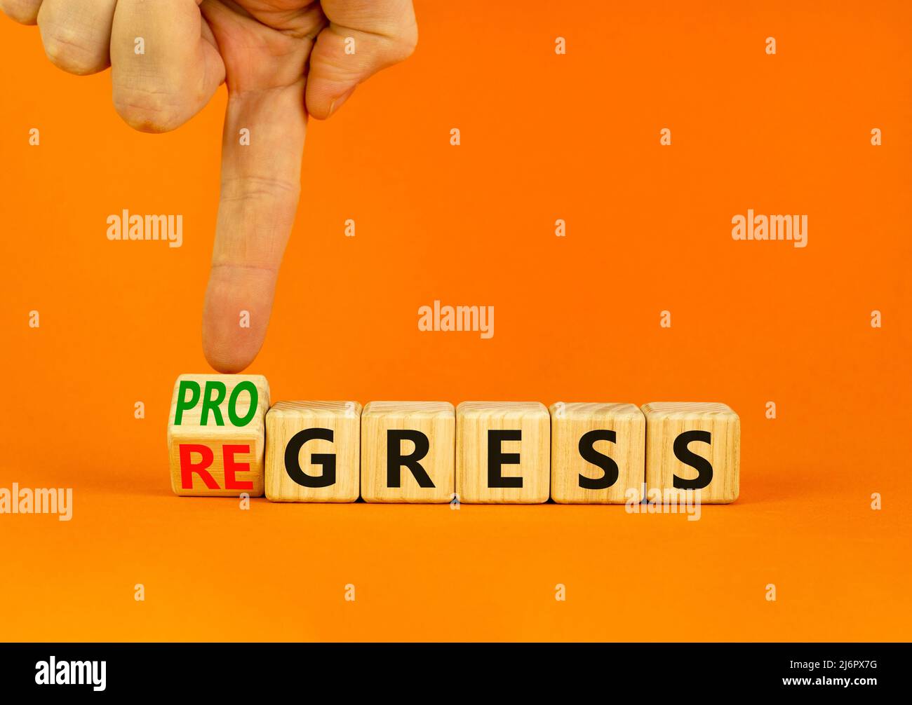 Regress or progress symbol. Businessman turns wooden cubes and changes ...