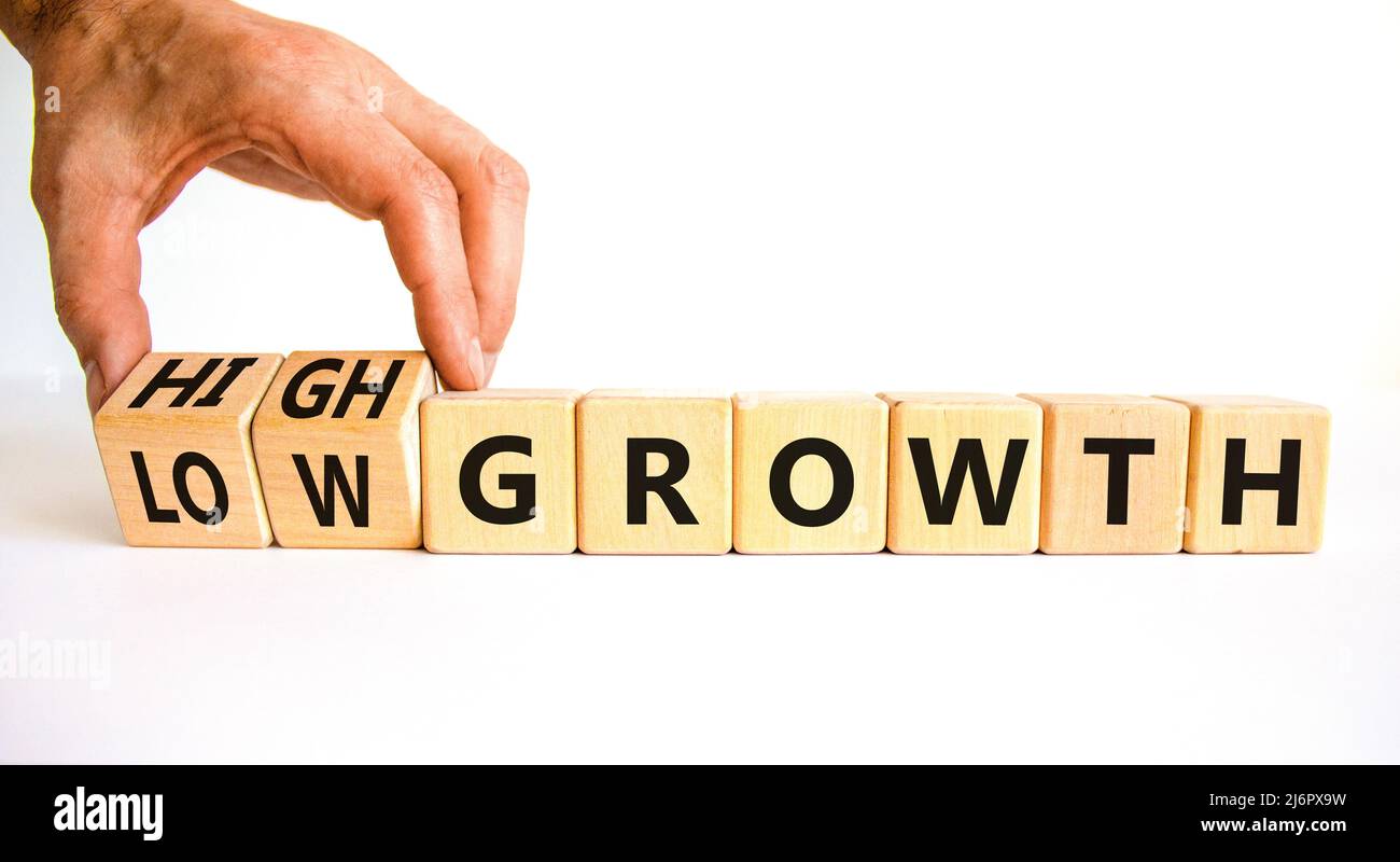 High or low growth symbol. Businessman turns wooden cubes and changes ...