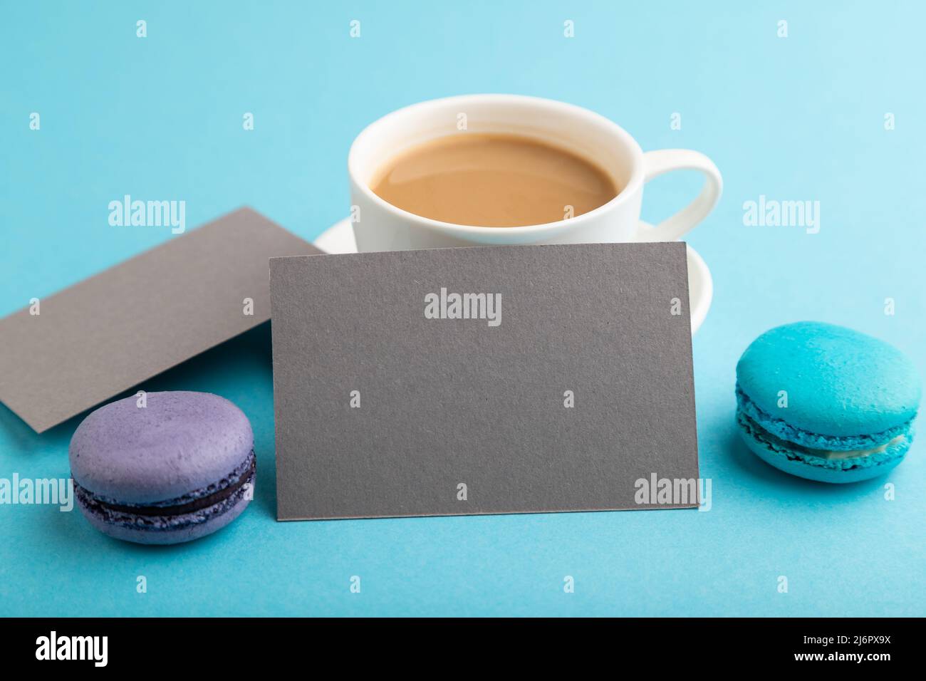 Gray paper business card mockup with blue and violet macaroons and cup ...