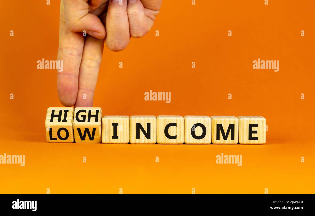 Low or high income symbol. Businessman turns wooden cubes and changes ...