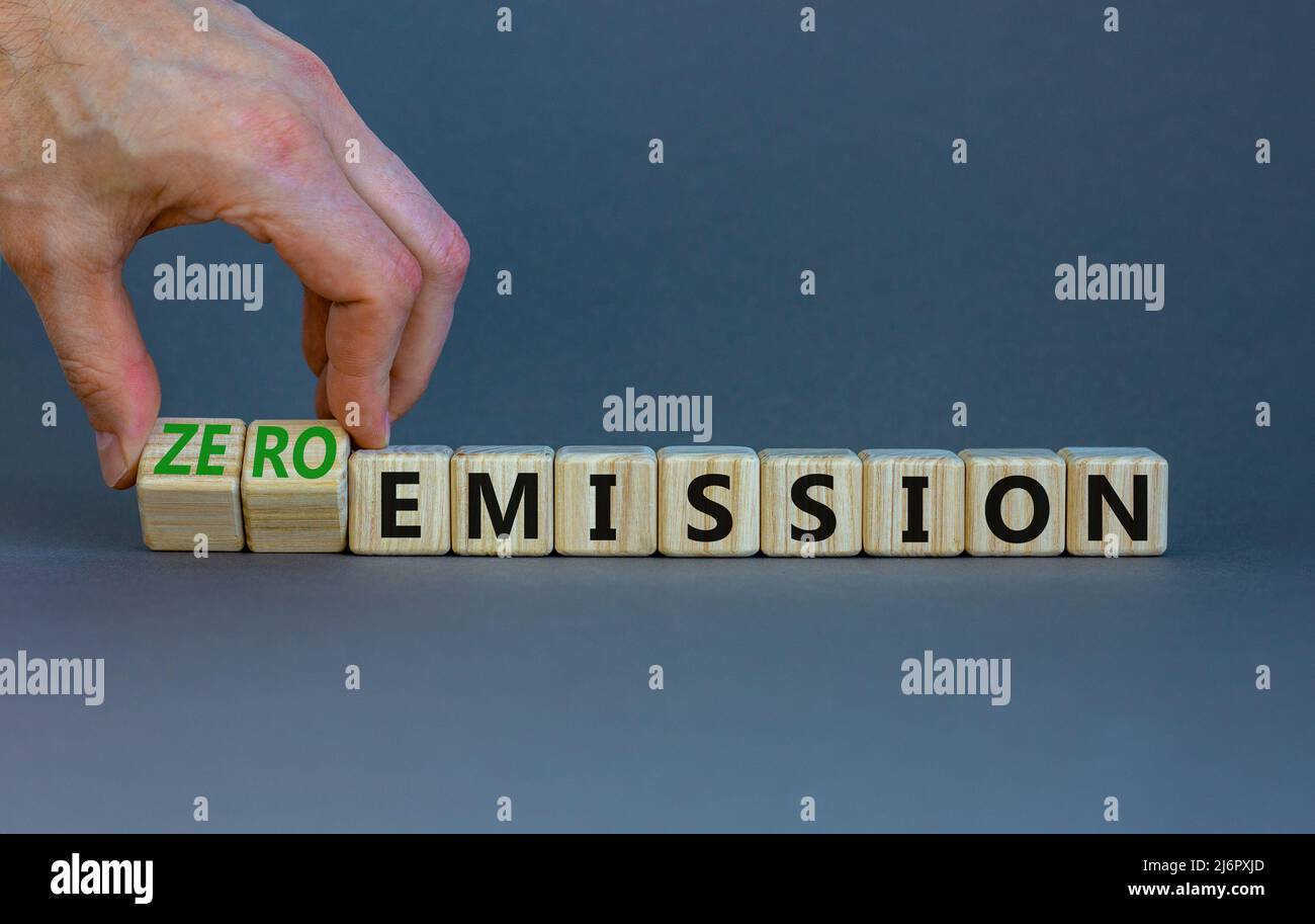 Zero emission symbol. Businessman turns wooden cubes and changes words ...