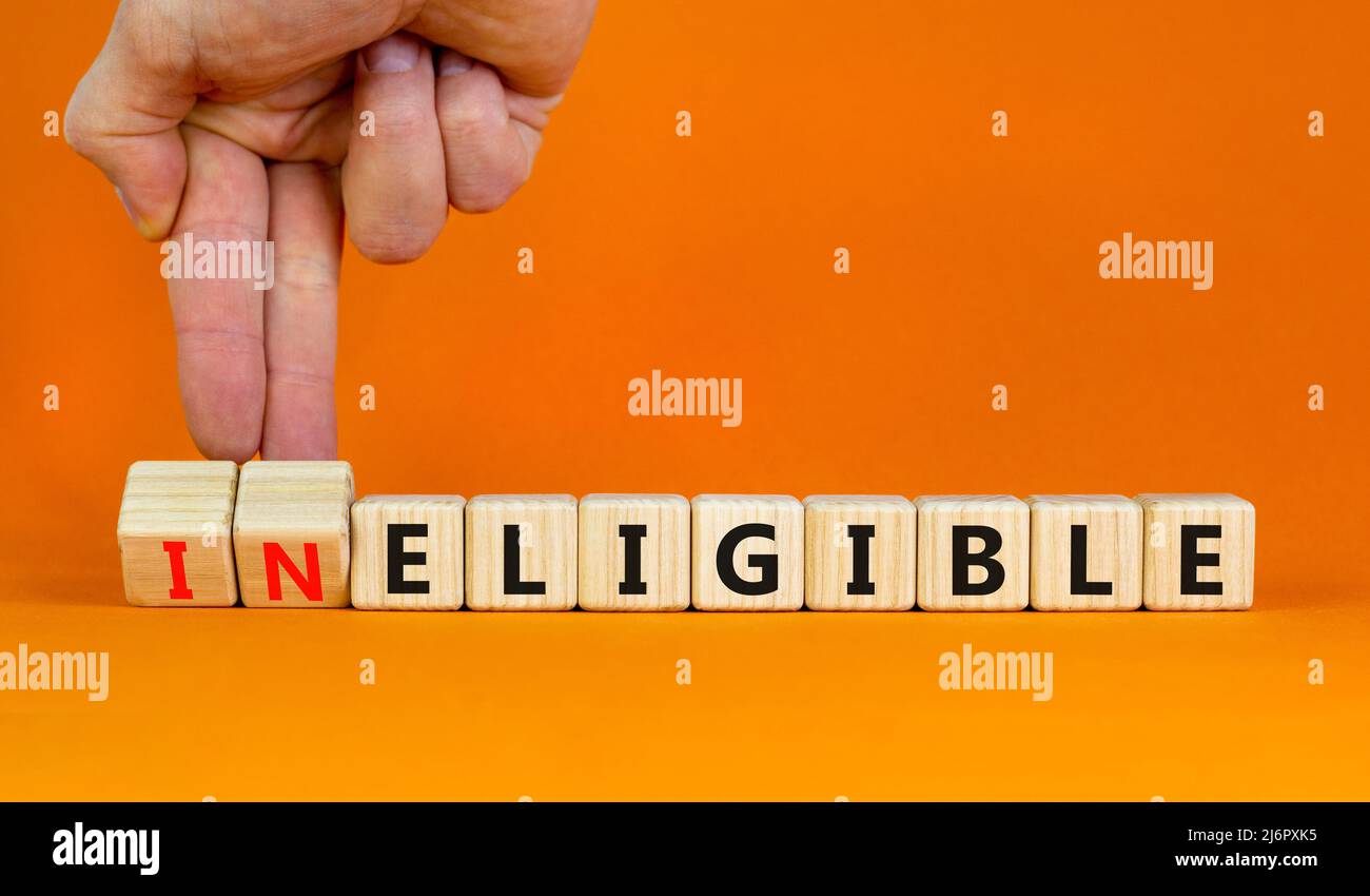 Eligible or ineligible symbol. Businessman turns wooden cubes and ...