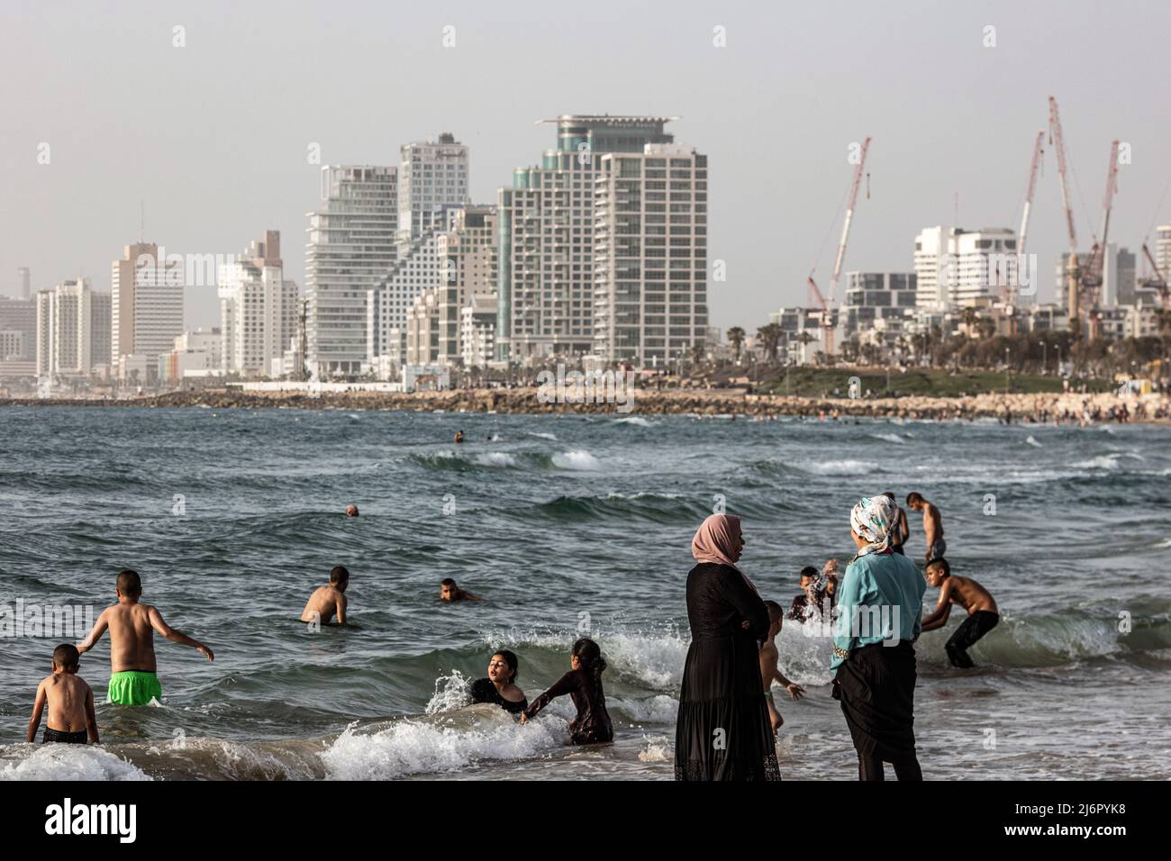 03 May 2022, Israel, Tel Aviv: People gather on the beach as they ...