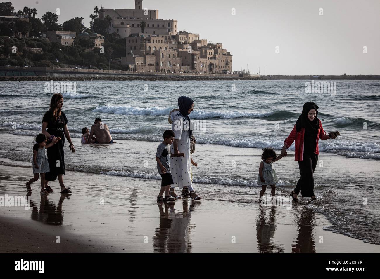 03 May 2022, Israel, Tel Aviv: People gather on the beach as they ...