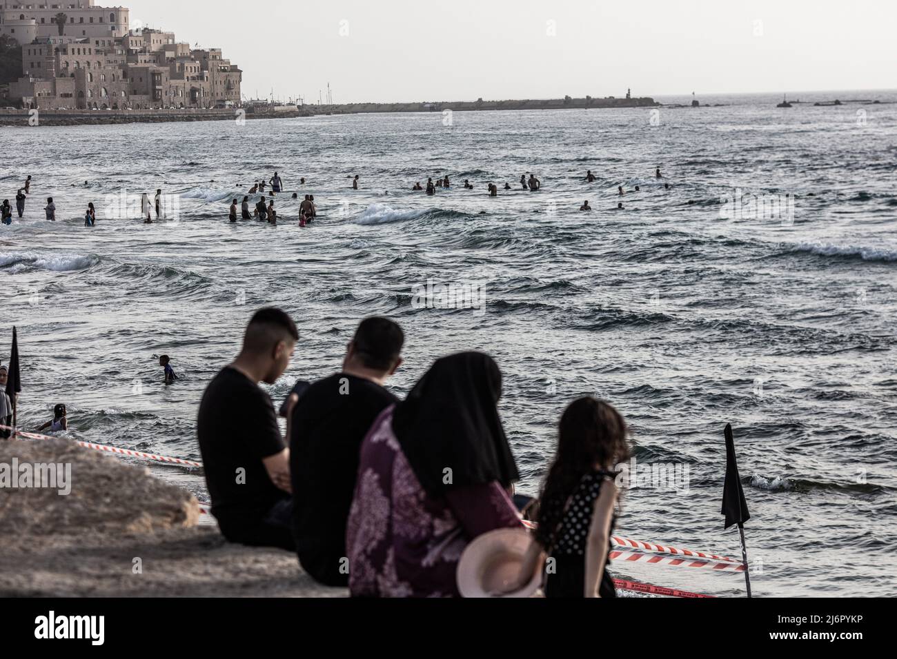 03 May 2022, Israel, Tel Aviv: People gather on the beach as they ...