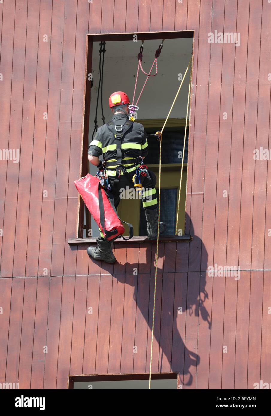 climber firefighter go in the house by window during emergency Stock ...