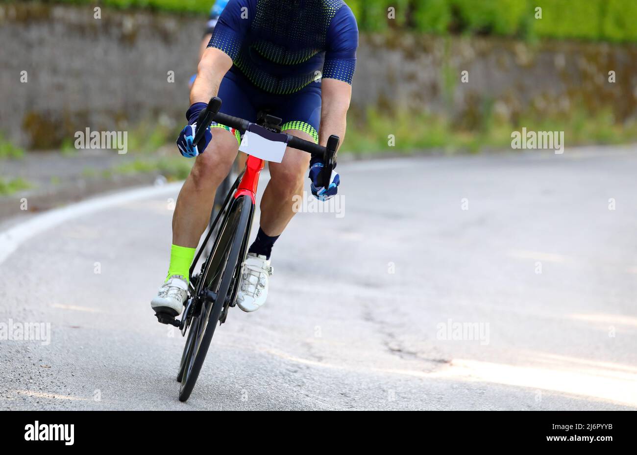 Cyclist on a racing bike engaged in the dangerous curve during the ...