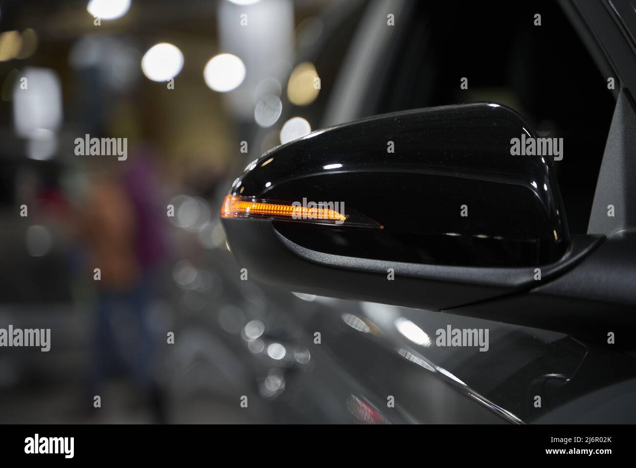Orange LED turn signal in the mirror of a modern car, close-up ...