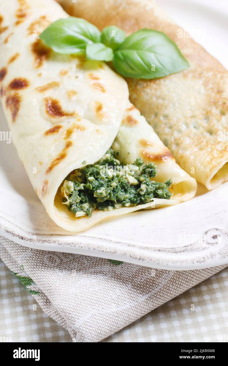Mediterranean cuisine: crepes stuffed with cheese and spinach. Healthy ...