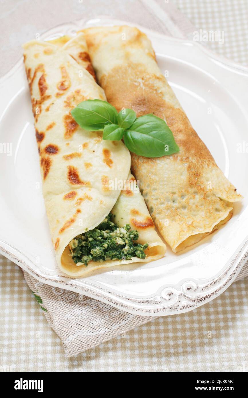 Mediterranean cuisine: crepes stuffed with cheese and spinach. Healthy ...