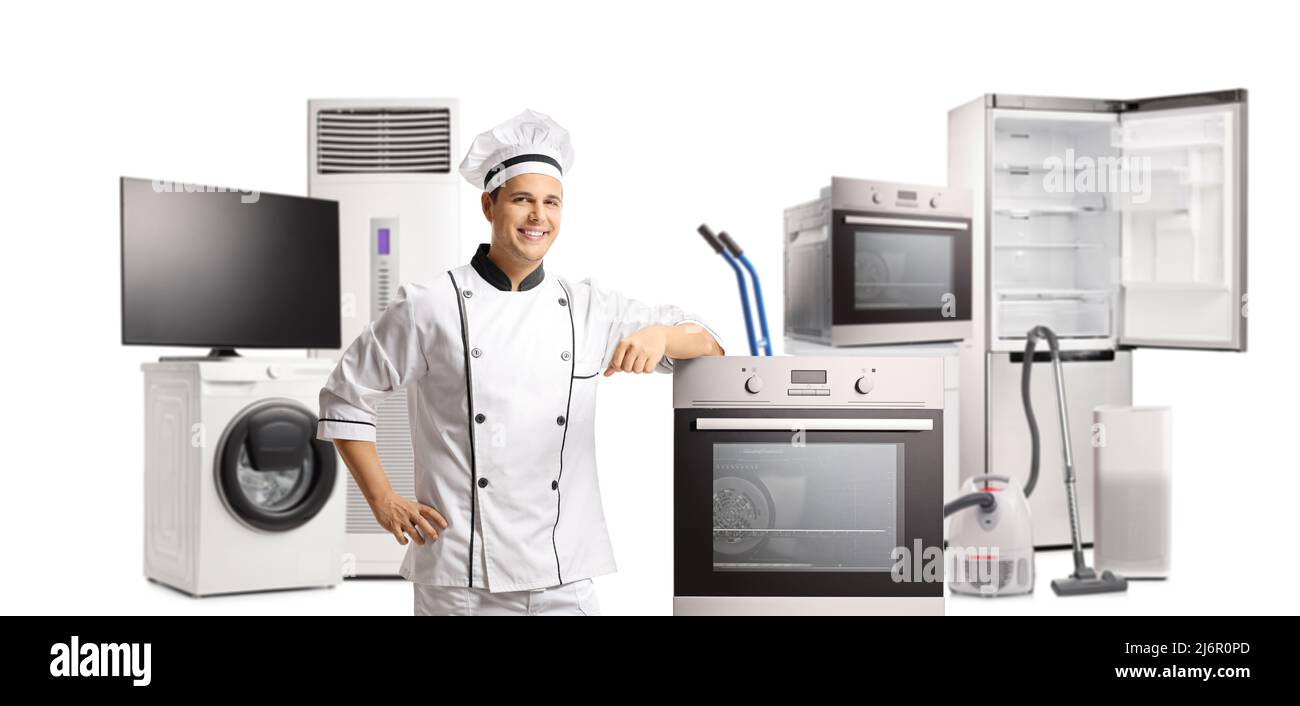 Male chef smiling and posing with electrical home appliances isolated ...