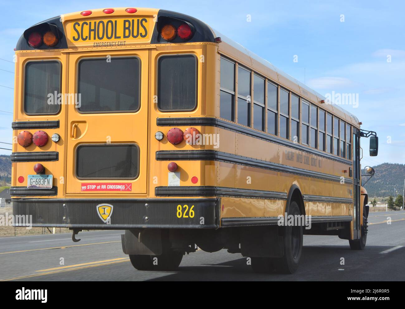 Traditional school buses on the road Stock Photo - Alamy