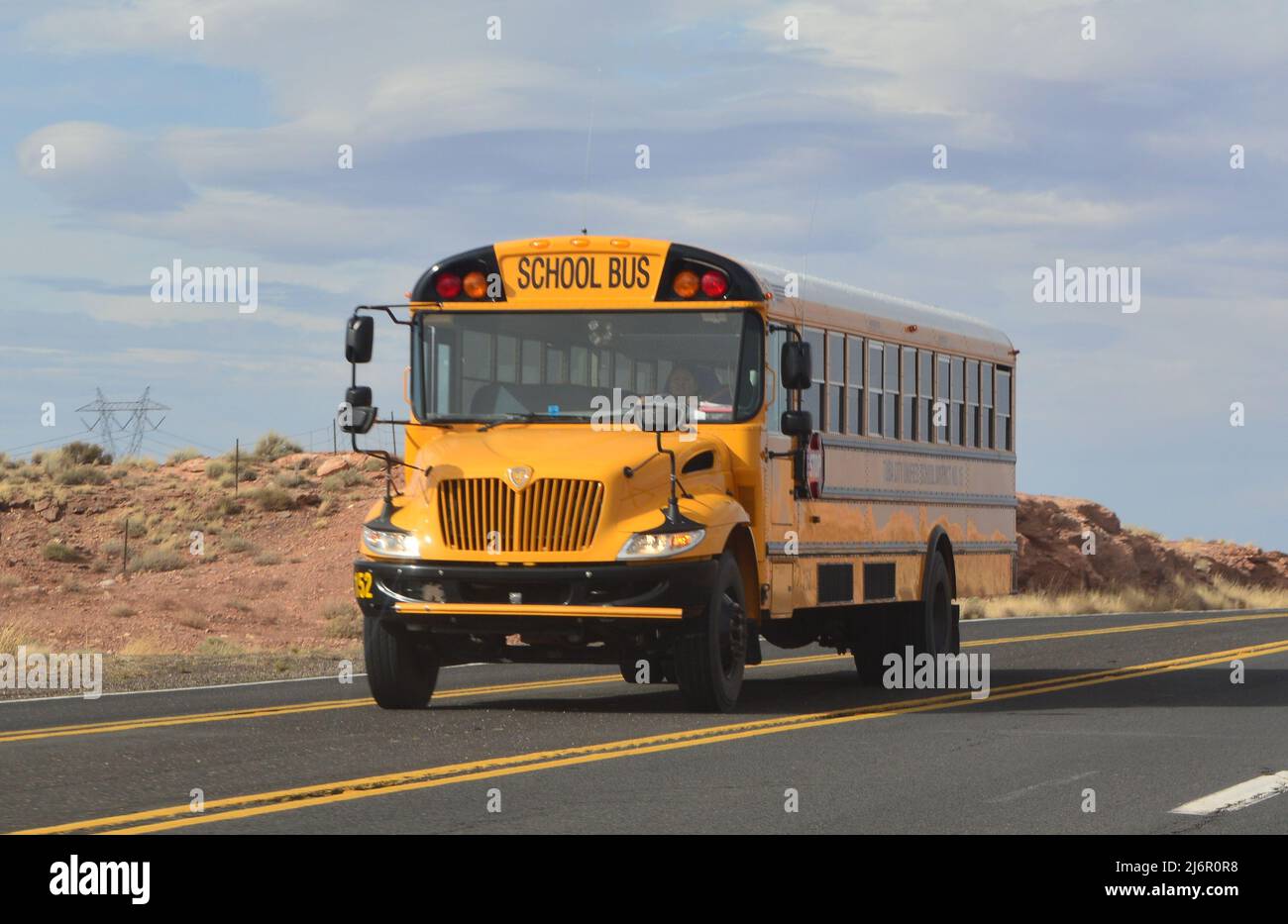 Traditional school buses on the road Stock Photo - Alamy