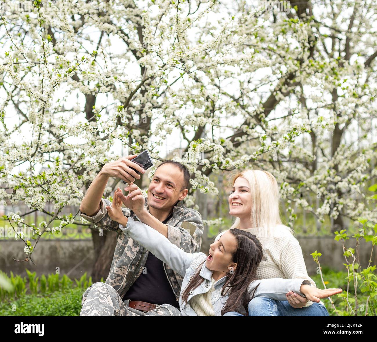 happy military family relaxing in the garden Stock Photo - Alamy