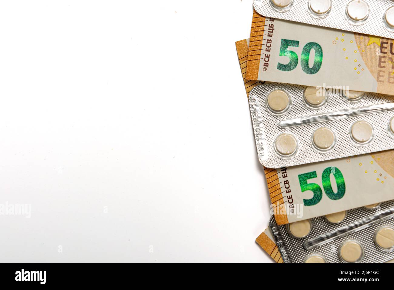 tablets in blister and fifty euro bills isolated on white, expensive ...