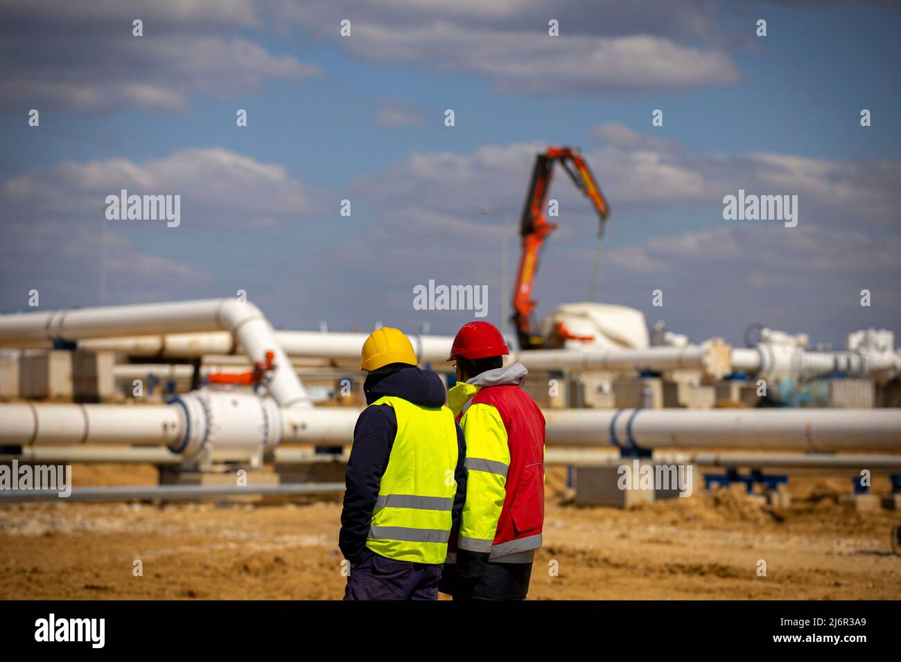 Workers work on a construction site of an interconnected natural gas ...