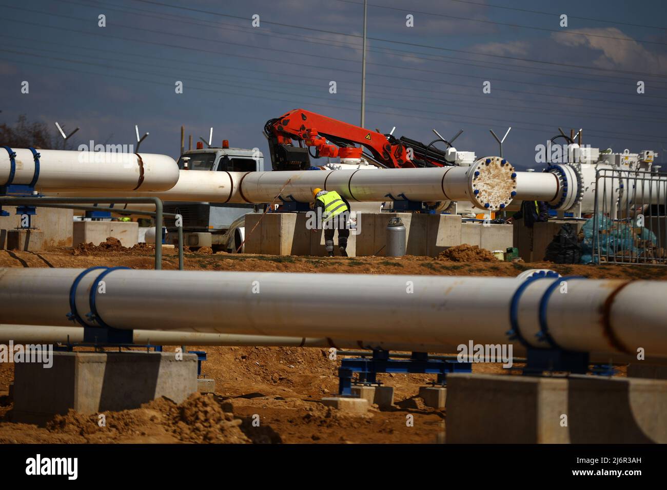 Worker works on a construction site of an interconnected natural gas ...