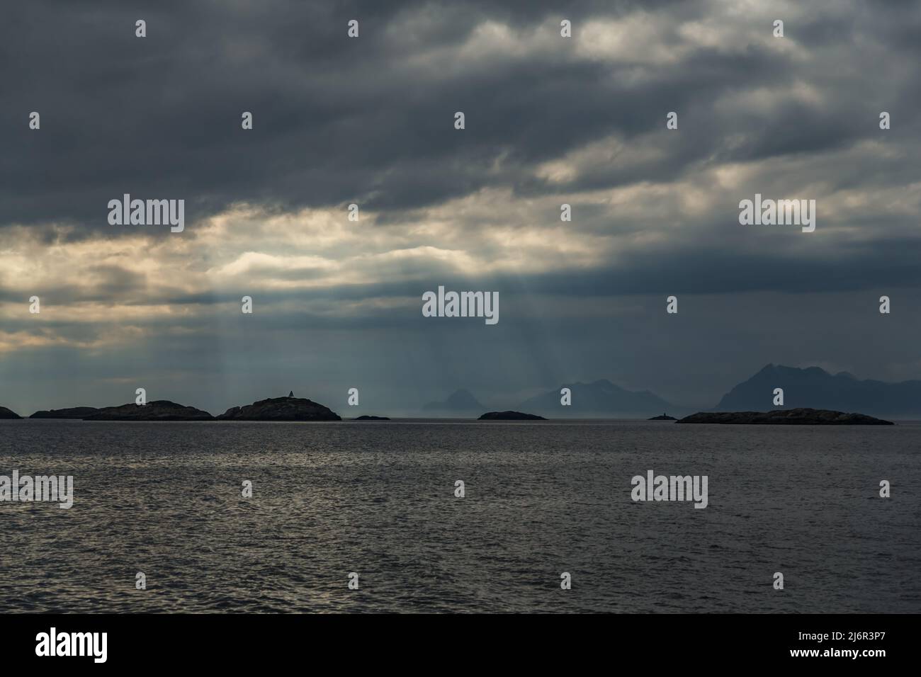 Norwegian seascape, rocky coast with dramatic skies, the sun breaks ...