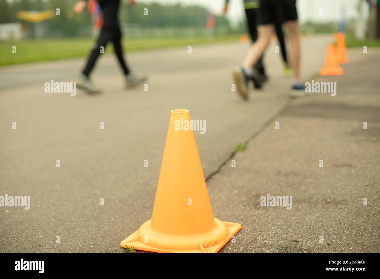 Orange cap on road. Warning sign. Direction limiter Stock Photo - Alamy