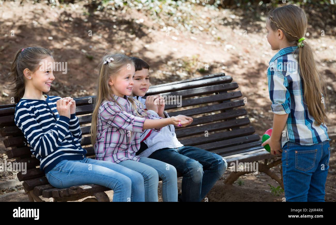 Children on the bench playing with ball Stock Photo - Alamy