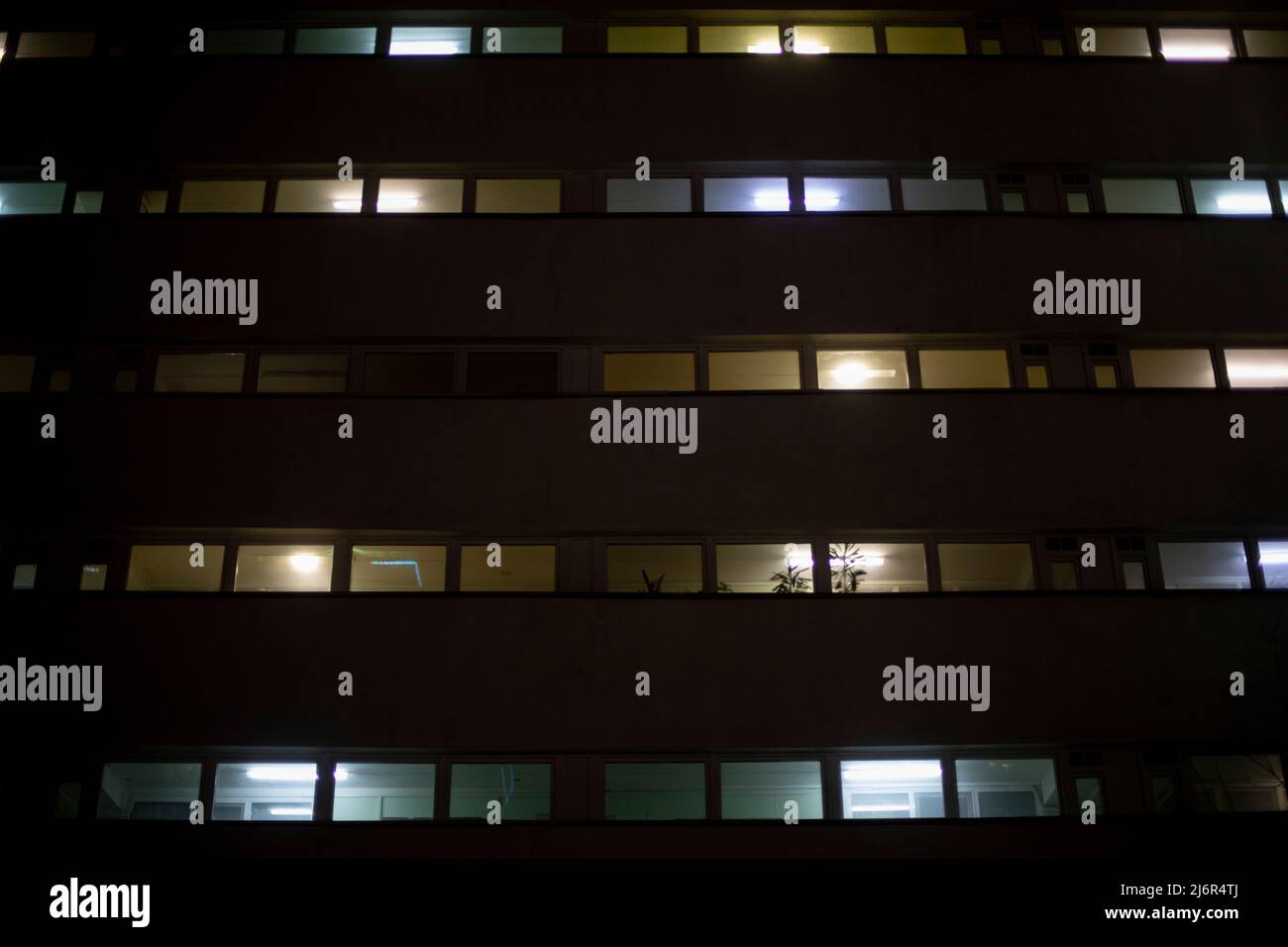 Windows in building at night. Unique architecture. Details of house ...