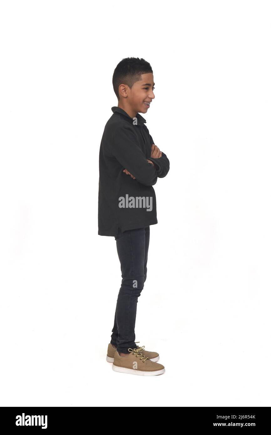 side view of a boy with arms crossed looking on white background Stock ...