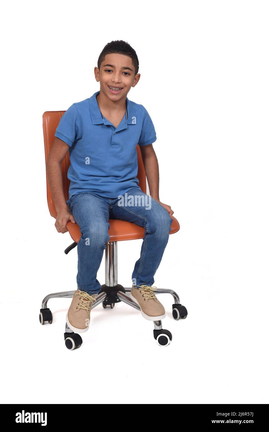 front view of a boy sitting on a chair on white background Stock Photo ...