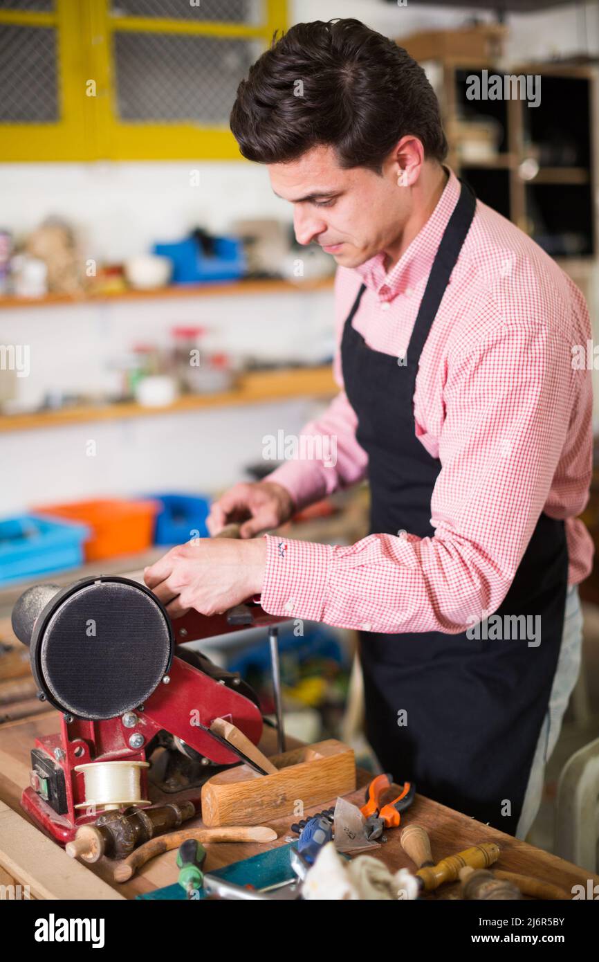 Craftsman working on woodworking machine Stock Photo - Alamy