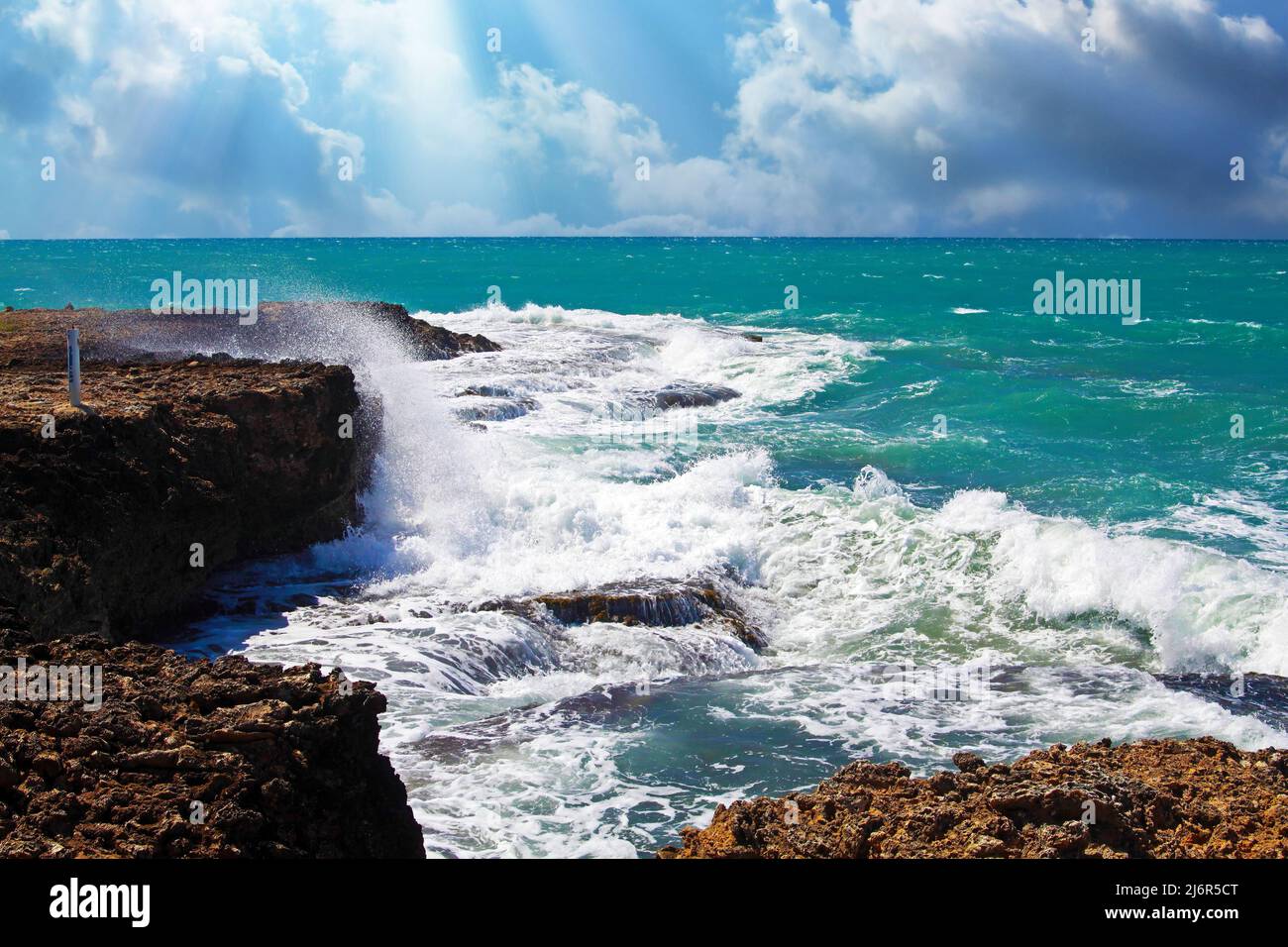 Beautiful caribbean coastal landscape with splashing waves, rough rocky ...