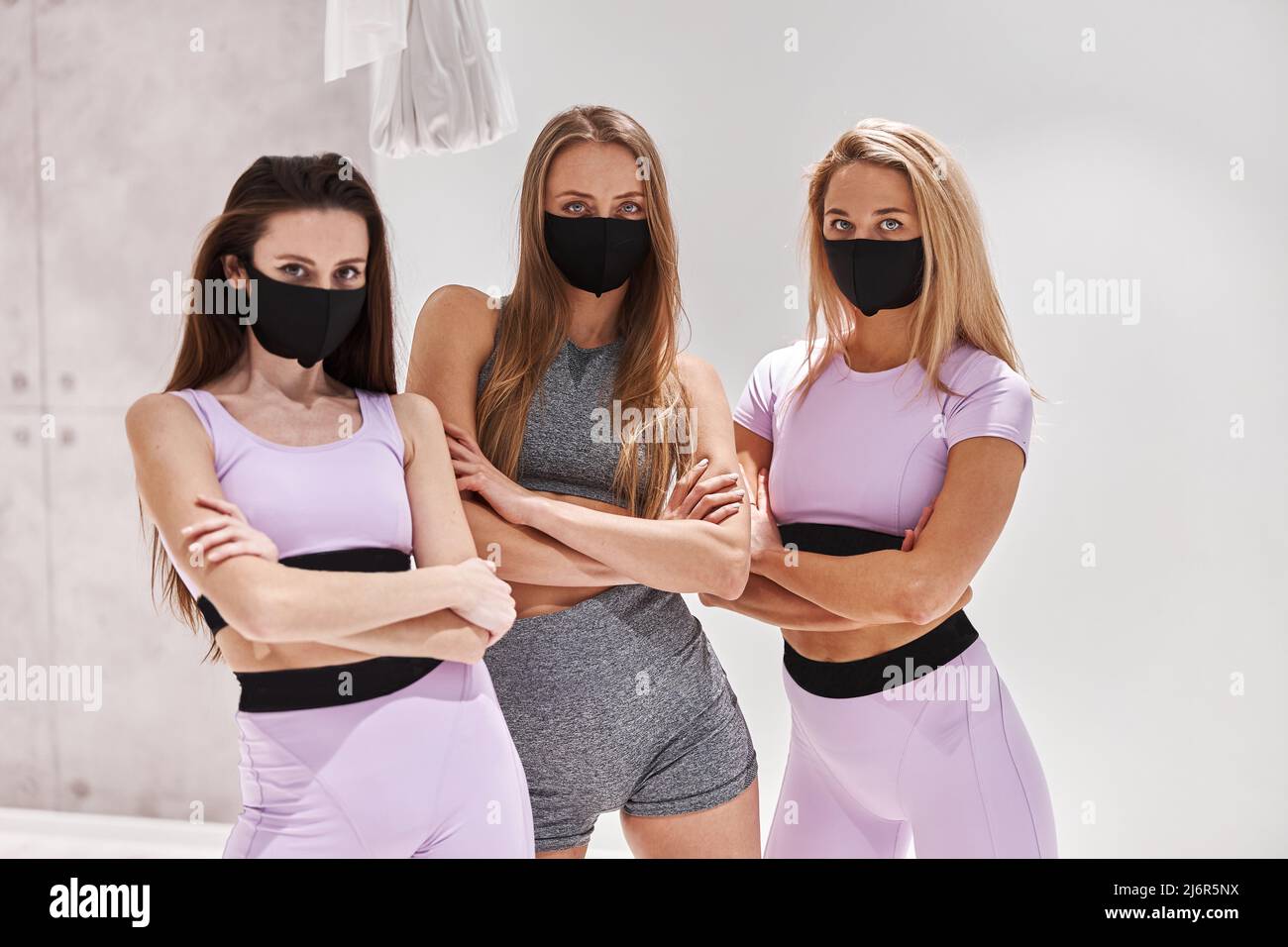 Young fit girls in sportswear with a mask on their faces came to ...