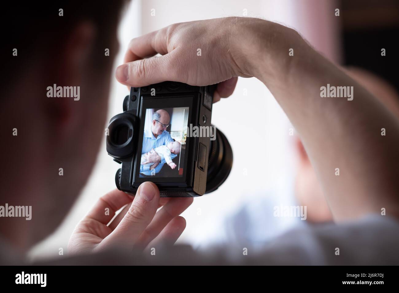 Photographing little child girl or shooting video on digital camera ...