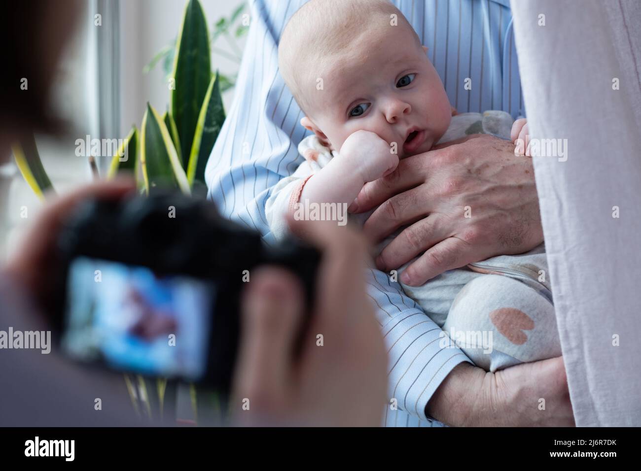 Photographing little child girl or shooting video on digital camera ...