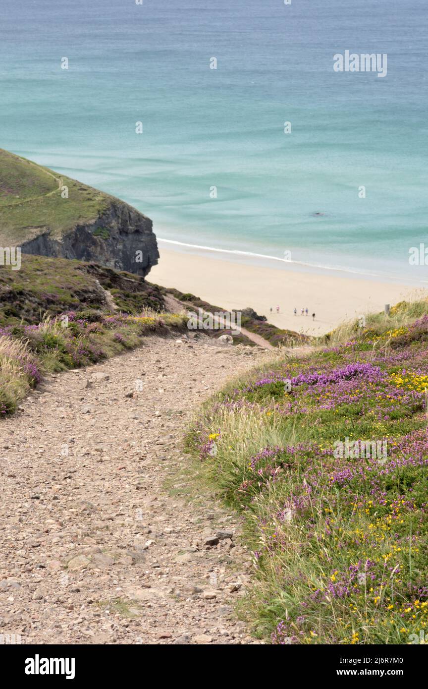 St. Agnes Bay, Cornwall - 2 July 202: Sandy beach with lone walkers and ...
