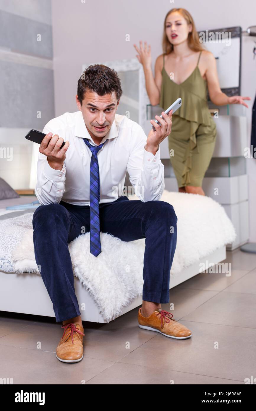 Furious man screaming on two phones Stock Photo - Alamy