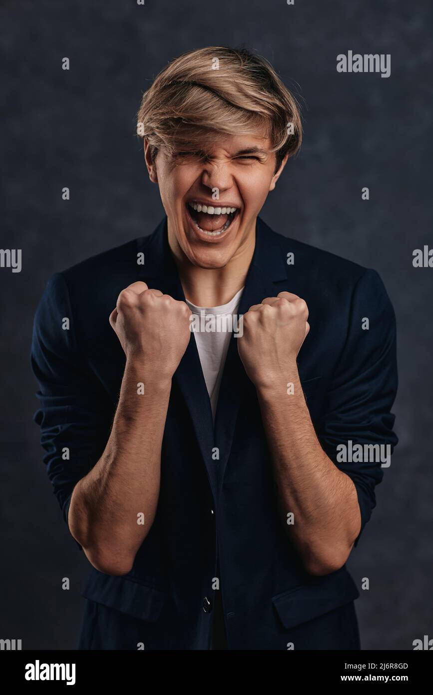 Crying emotional angry young man screams on gray background Stock Photo ...