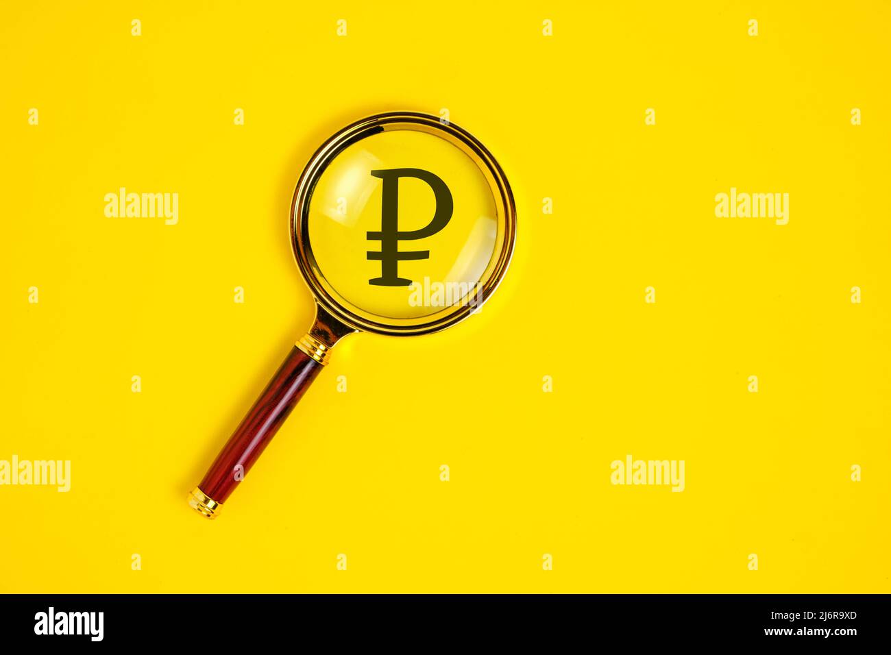 Ruble symbol under magnifying glass, on yellow background Stock Photo ...