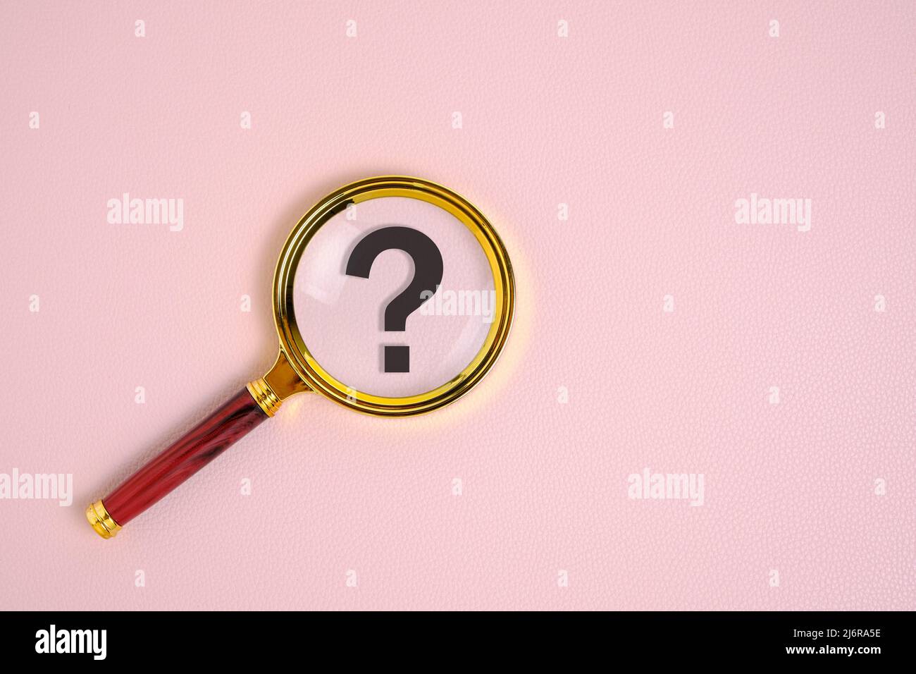 Question mark under magnifying glass, on pink background Stock Photo ...