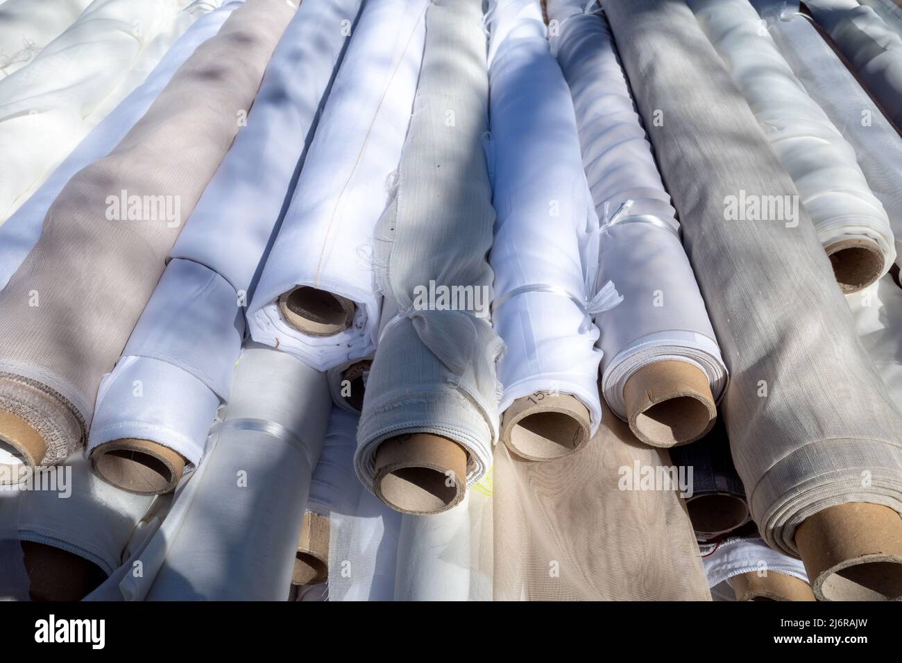White fabric rolls stack on textile stall outdoor market Stock Photo ...