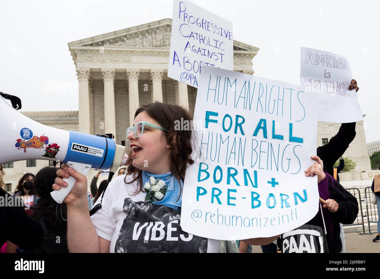 Woman with a sign saying "Human rights for all human beings born + pre ...
