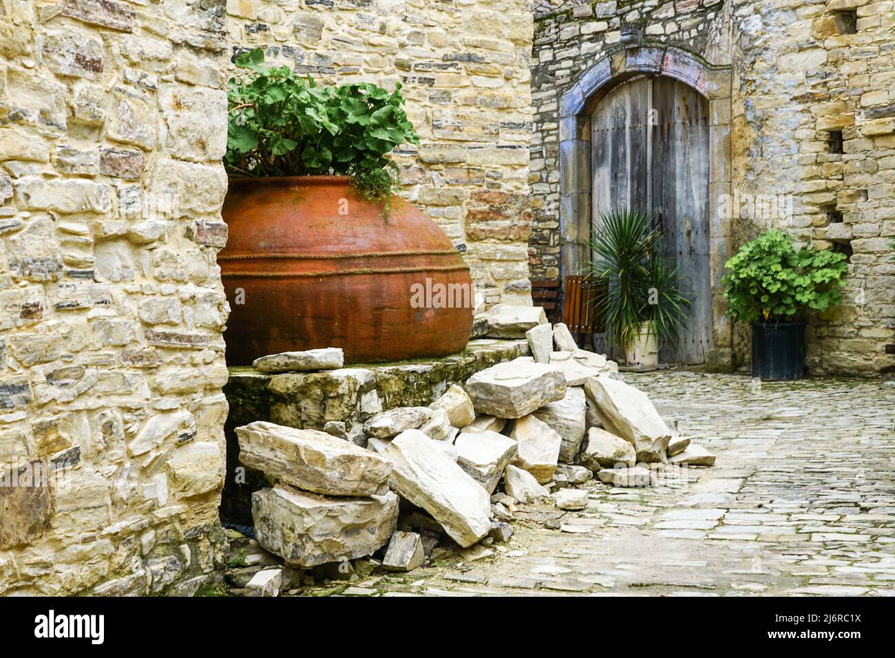 traditional idyllic yard in a mountain village in Cyprus with large old ...