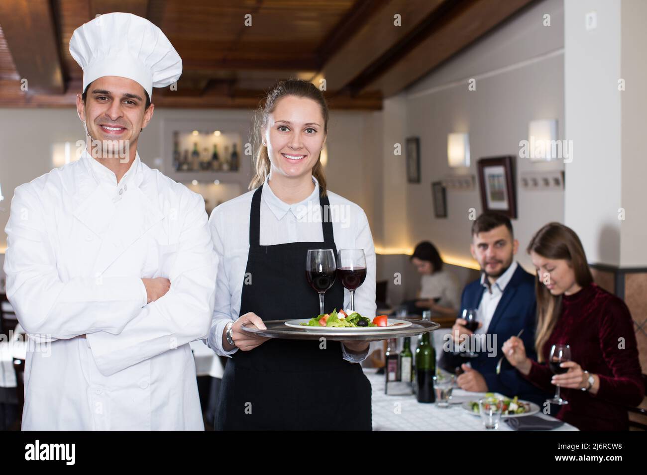 Portrait of confident male chef and smiling waitress Stock Photo - Alamy
