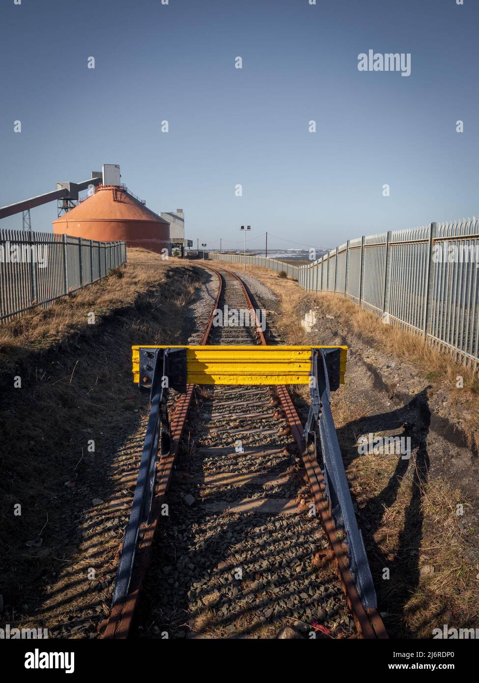 Buffers at the end of a British railway line in an industrial landscape ...