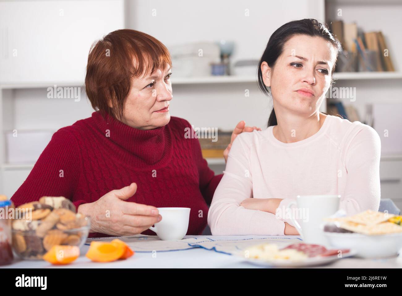 Portrait of sad mature woman talking with daughter Stock Photo - Alamy