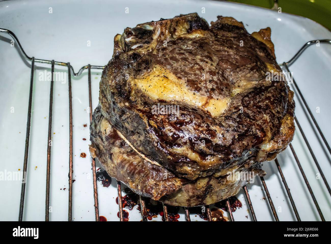 Cooked two bone standing rib beef roast on rack in roasting pan Stock ...