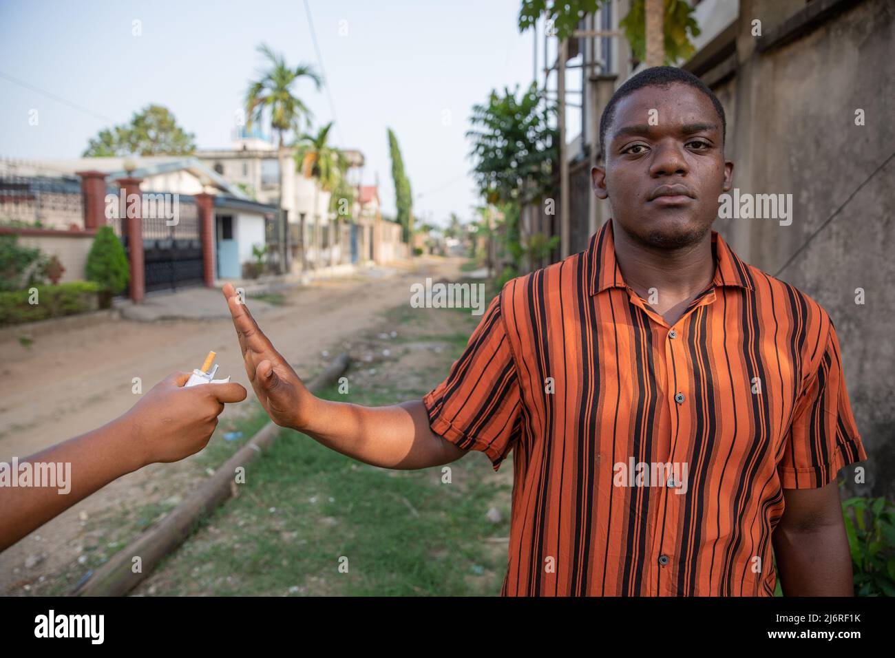 A guy refuses to take a cigarette from a pack of cigarettes, he is ...