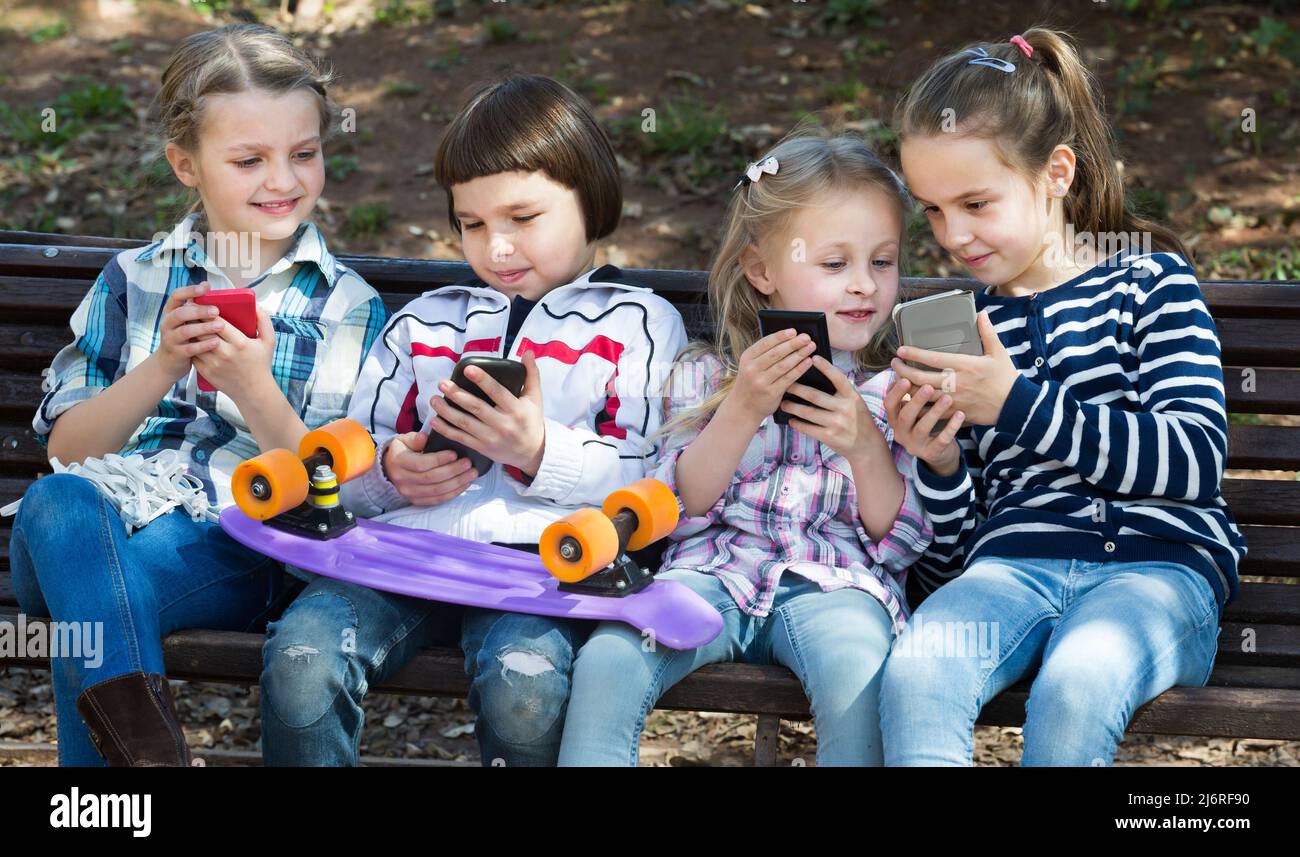 Portrait of junior kids playing with phones Stock Photo - Alamy