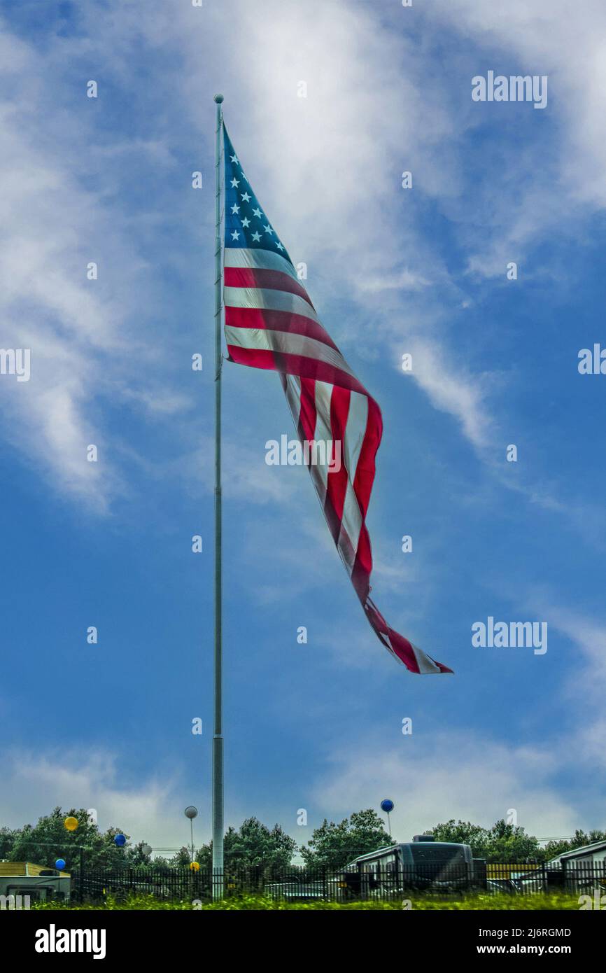 Giant American flag flying over campground under dramatic cloudy blue ...